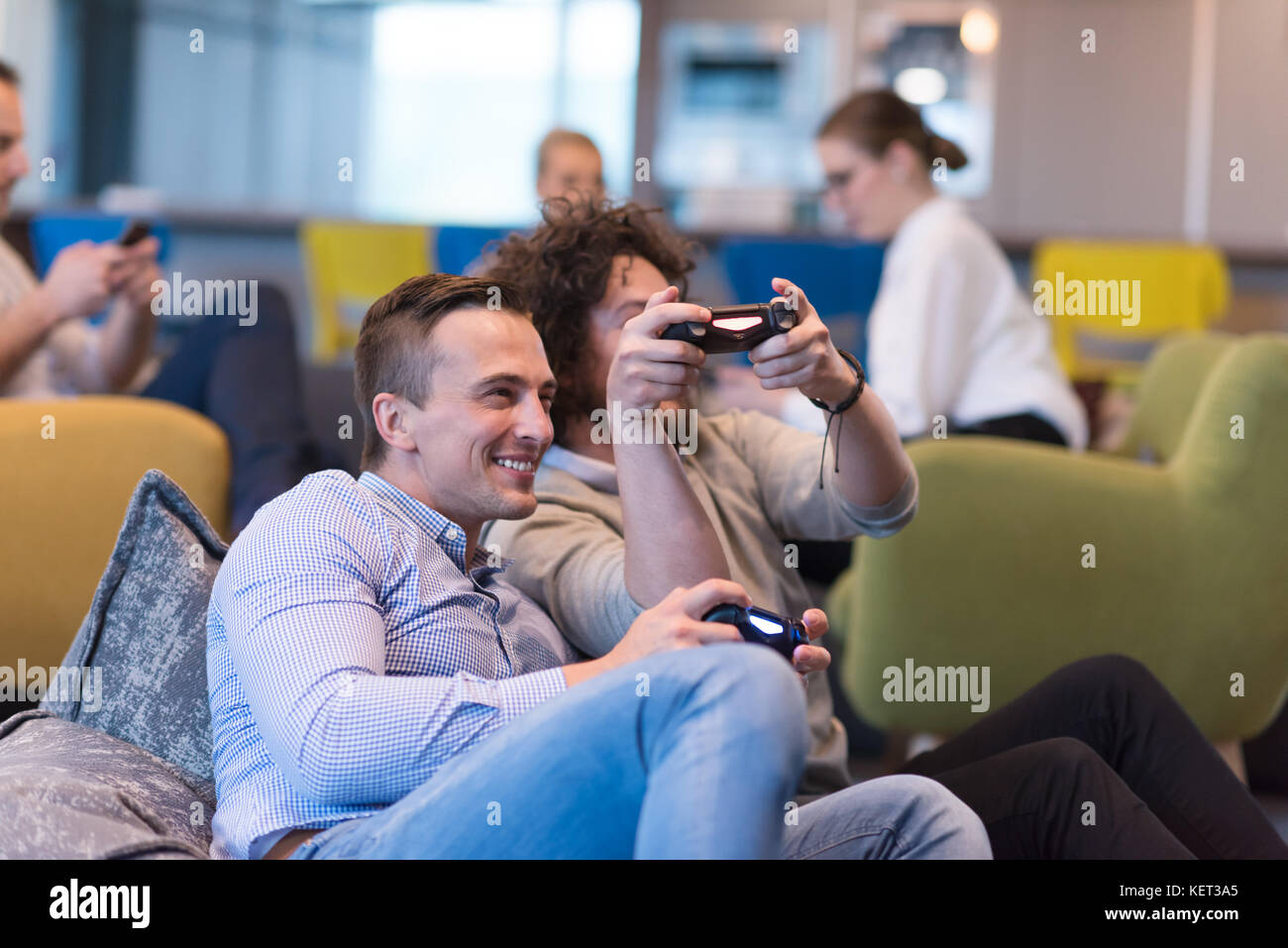 Work hard play hard. Workers Playing computer games in creative startup ...