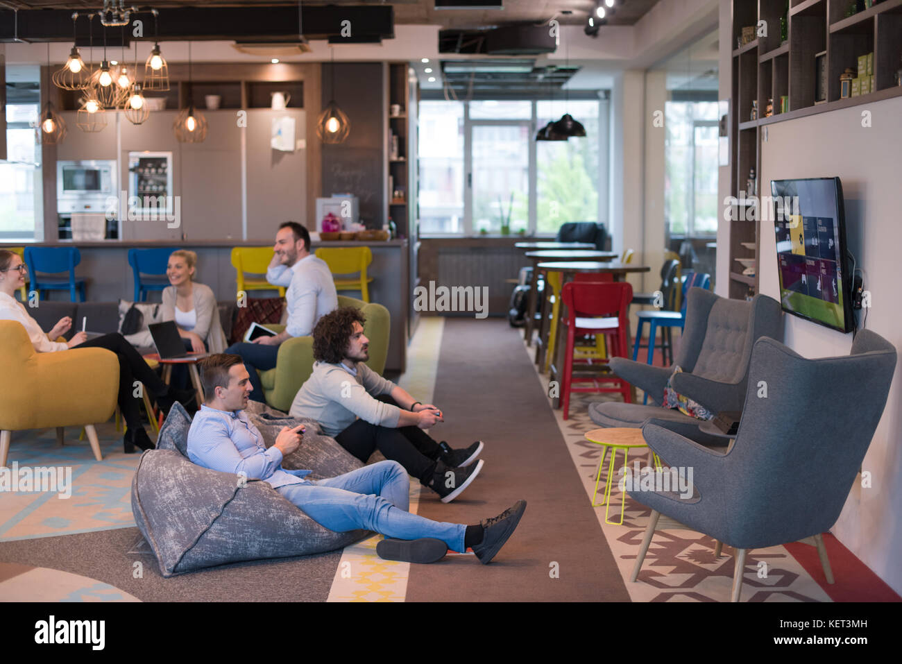 Work hard play hard. Workers Playing computer games in creative startup ...