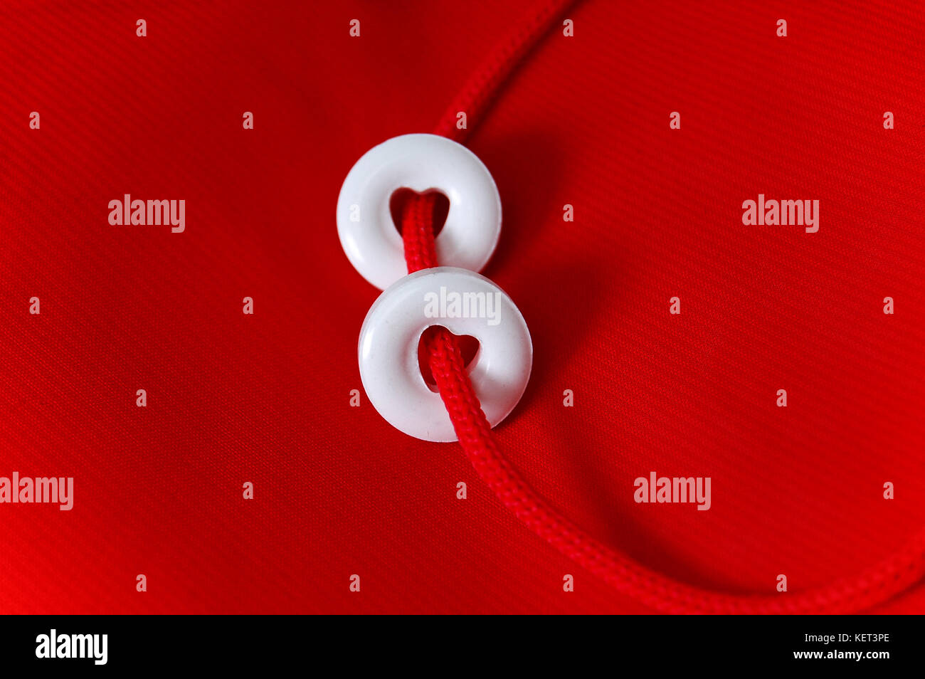 candy with a heart shape in the middle linked together with red rope ...