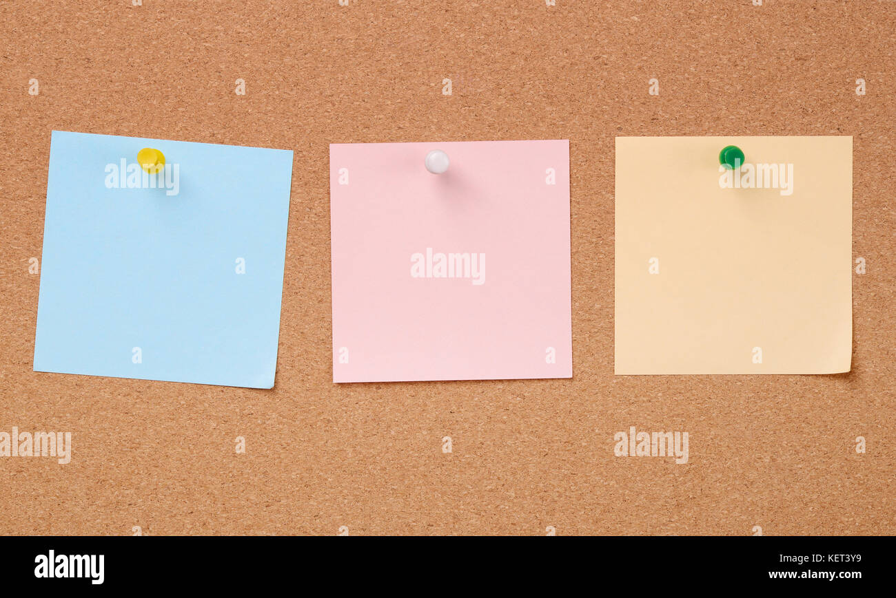 Row of three colors paper notes on cork board Stock Photo - Alamy