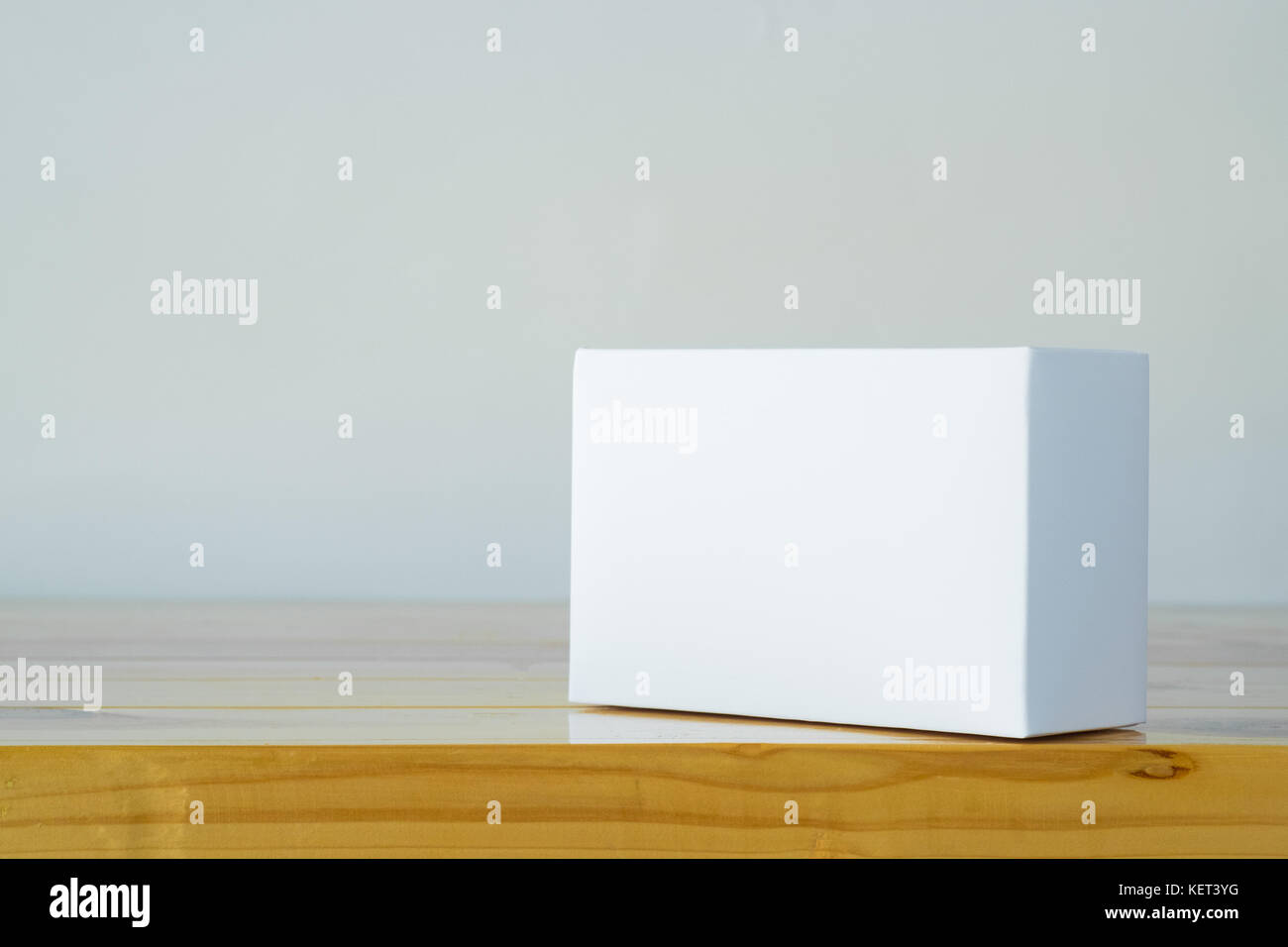 Empty white gift box for mock up on bright wooden table with copy space ...