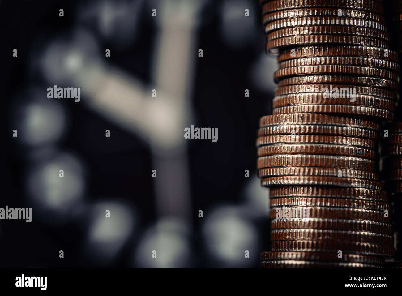 Alarm clock and piles of coin on working table, time for savings money ...