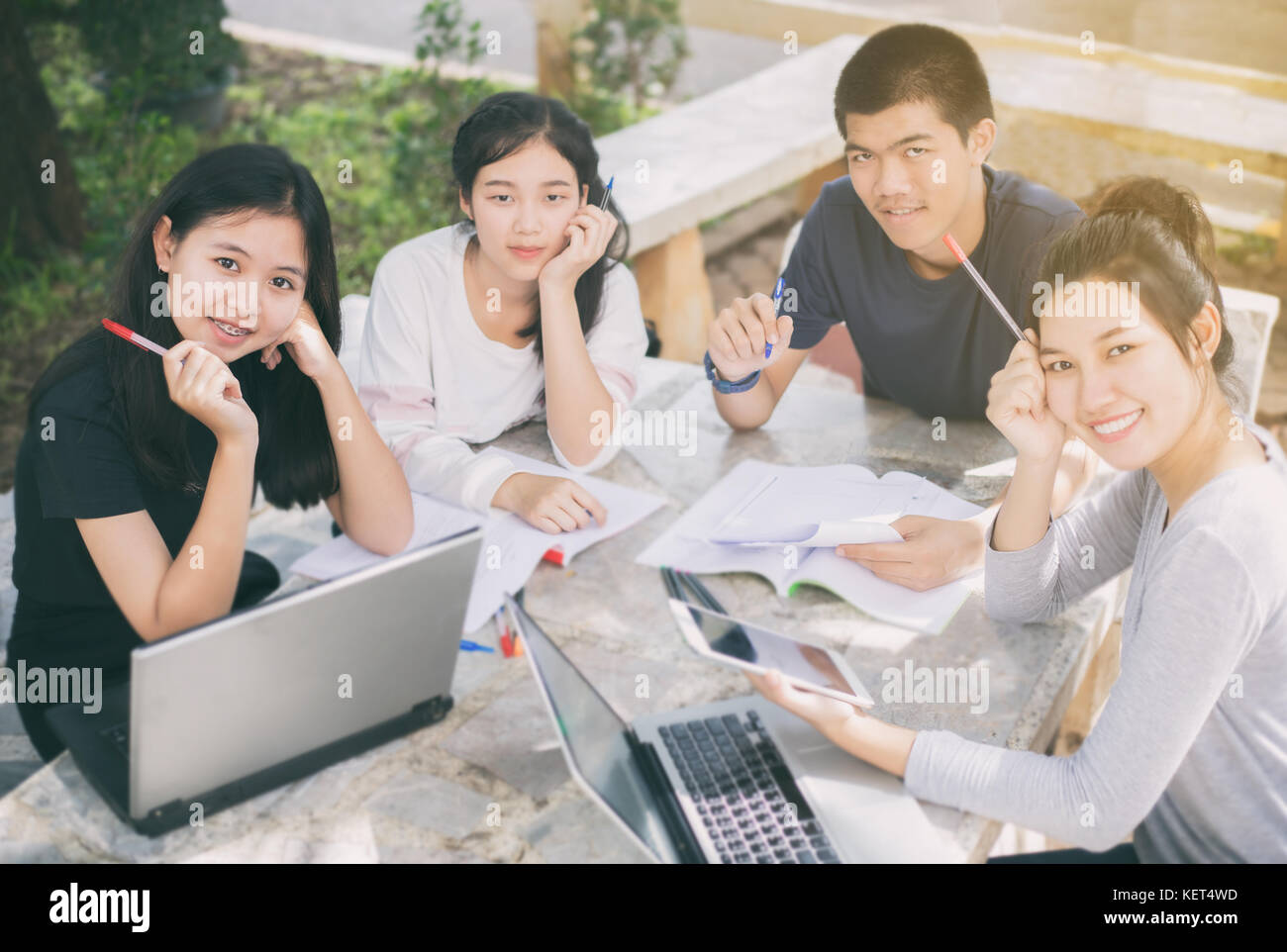 Asian Group of students smiling and sharing with the ideas for working ...