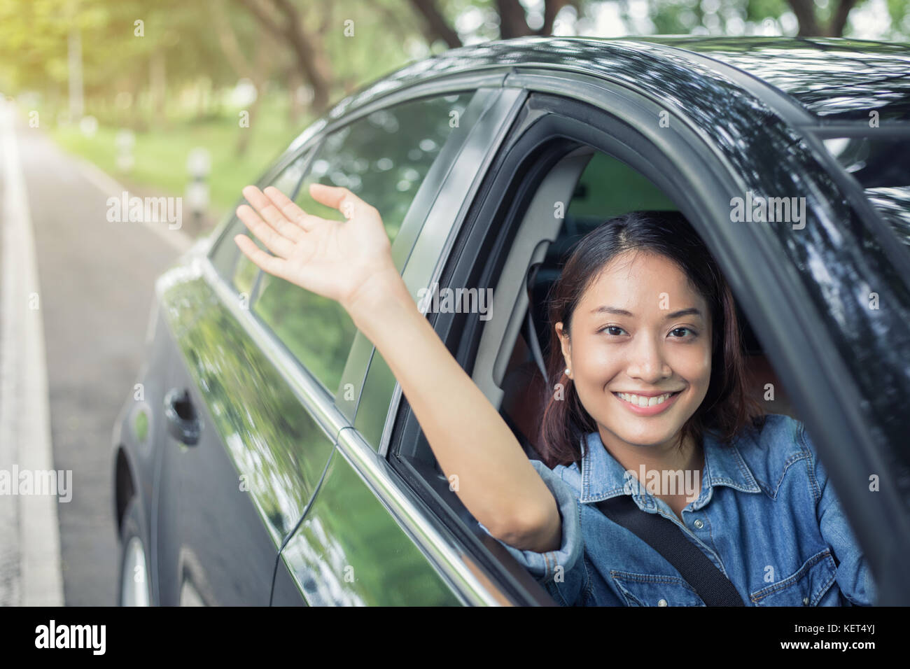 Beautiful Asian woman smiling and enjoying.driving a car on road for ...