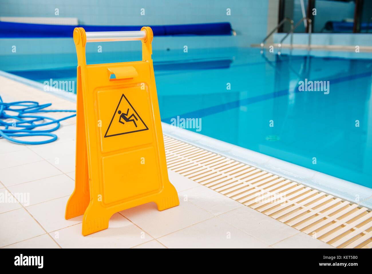 Slippery Swimming Pool Floor. Yellow Warning Sign Stock Photo - Alamy
