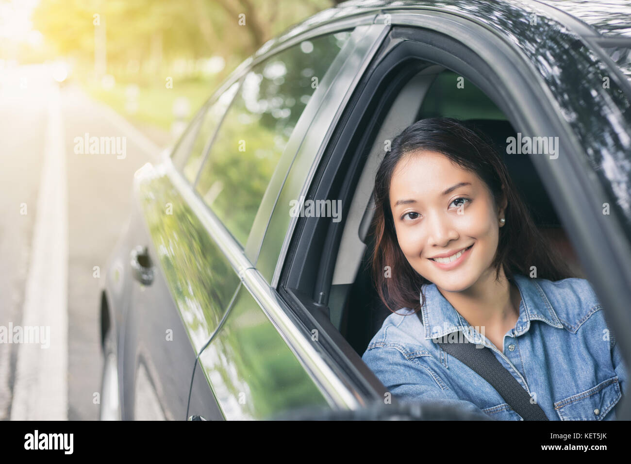 Beautiful Asian woman smiling and enjoying.driving a car on road for ...