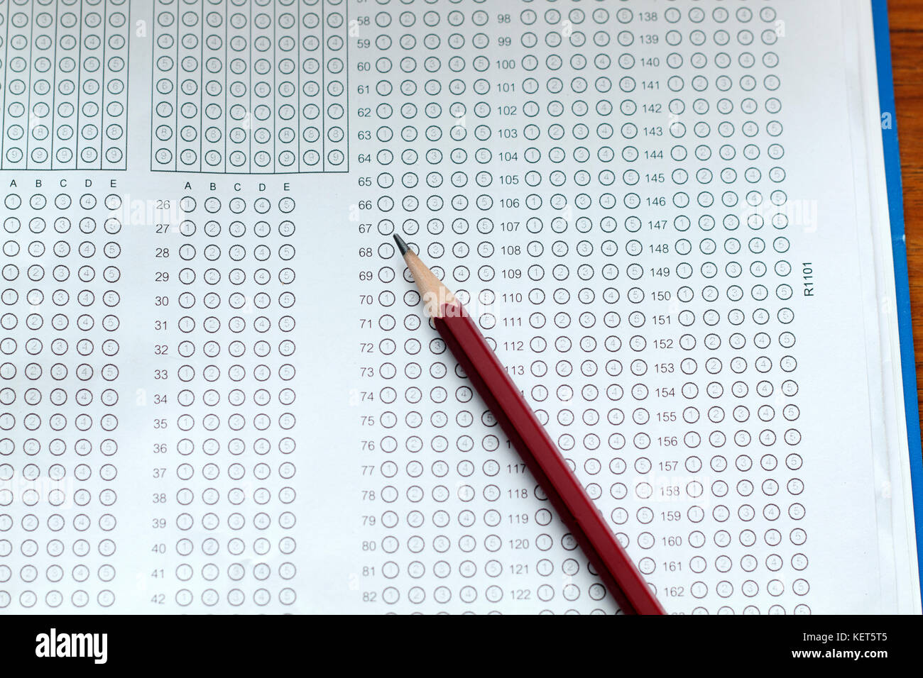glasses and pencil on Standardized test form with answers bubbled in ...