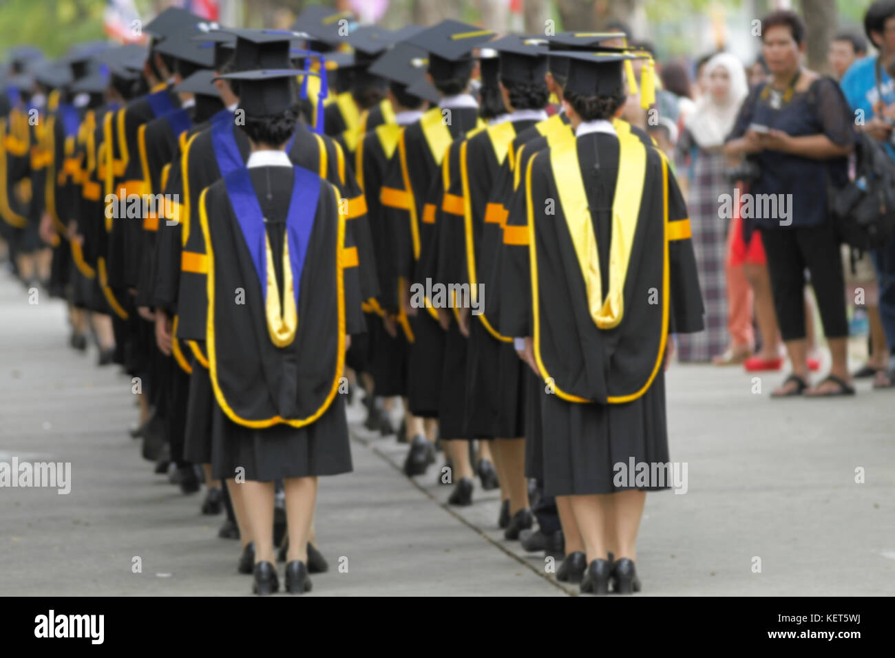 blurry of Graduates are walking the line to get a diploma and selective ...