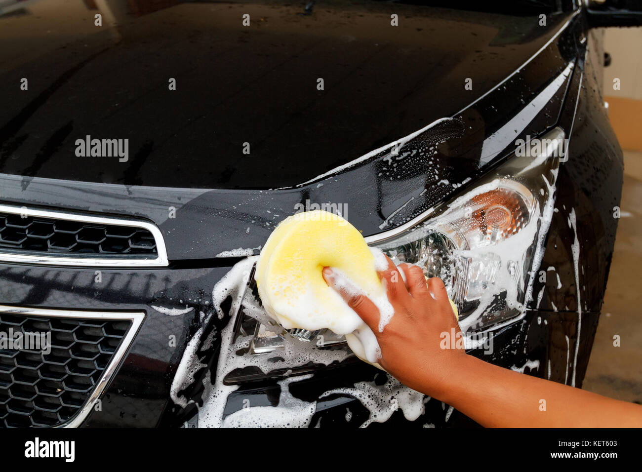 hand of Man washing the car using the yellow sponge with foam Stock ...
