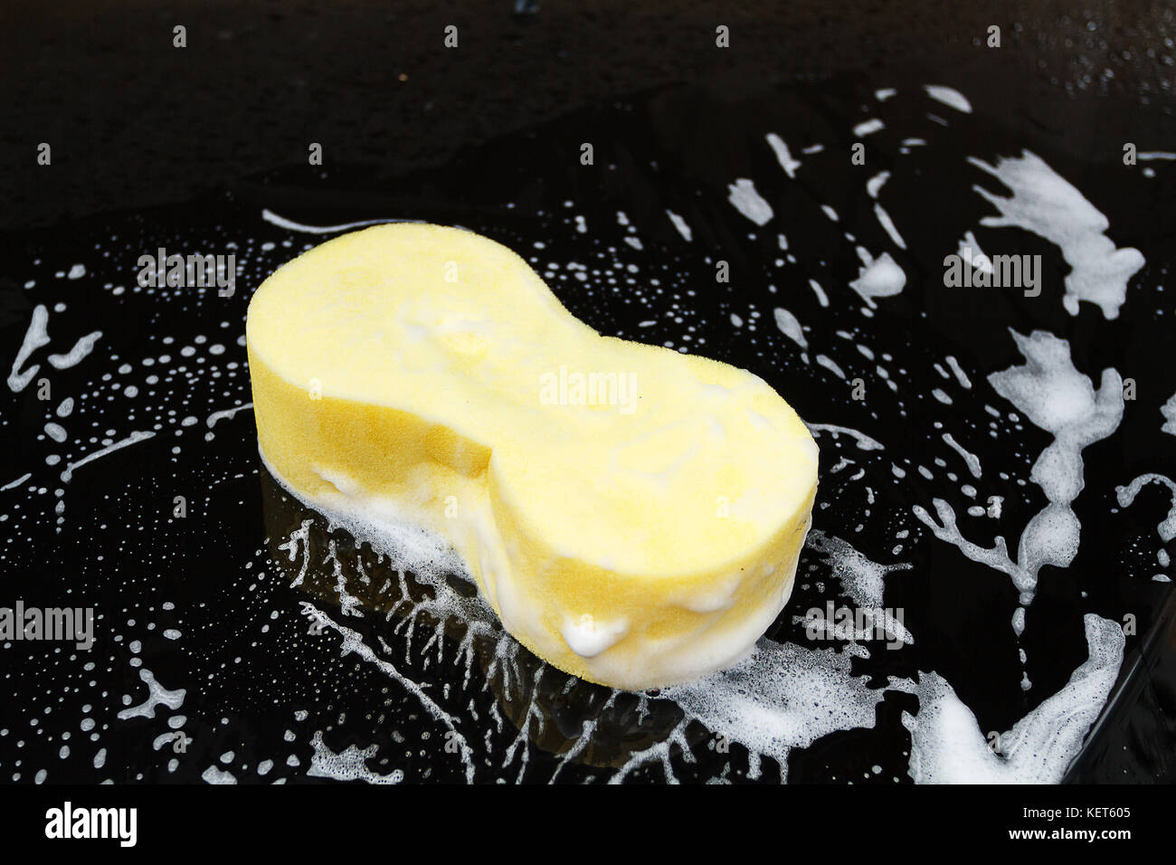washing the car using the yellow sponge with foam Stock Photo - Alamy
