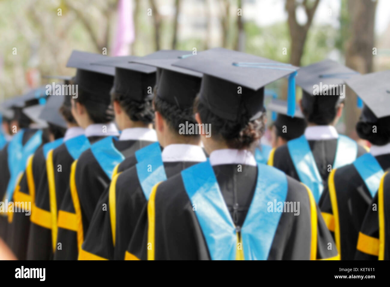blurry of Graduates are walking the line to get a diploma and selective ...