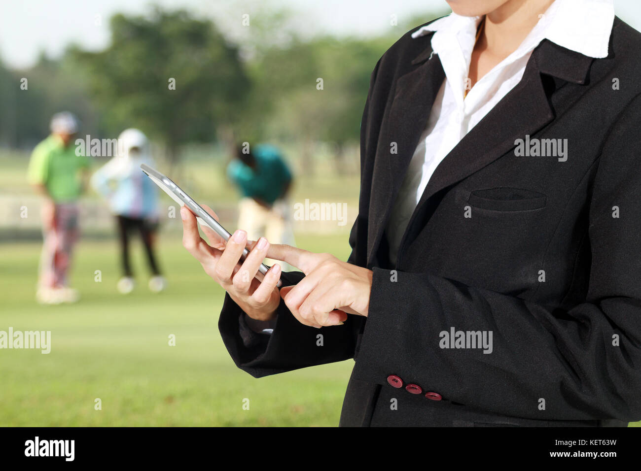 Businessmen and women are using mobile and touch smart phone on golfers ...