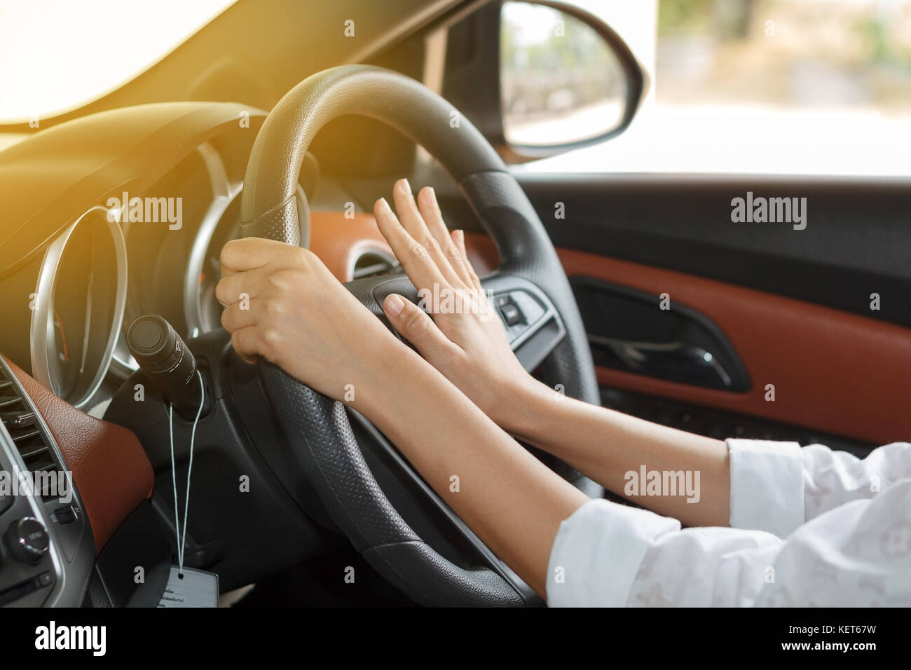 Asian women are driving cars on the road and squeeze klaxon.soft focus ...