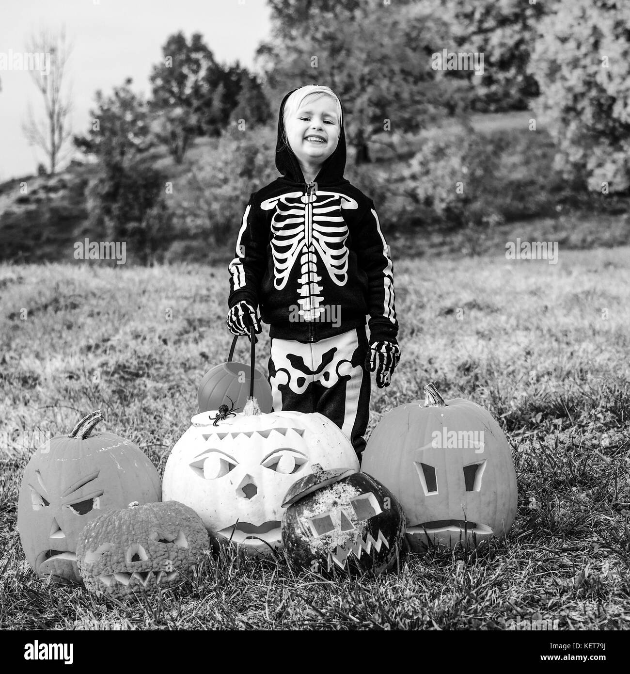 Trick or Treat. Full length portrait of happy girl wearing skeleton ...