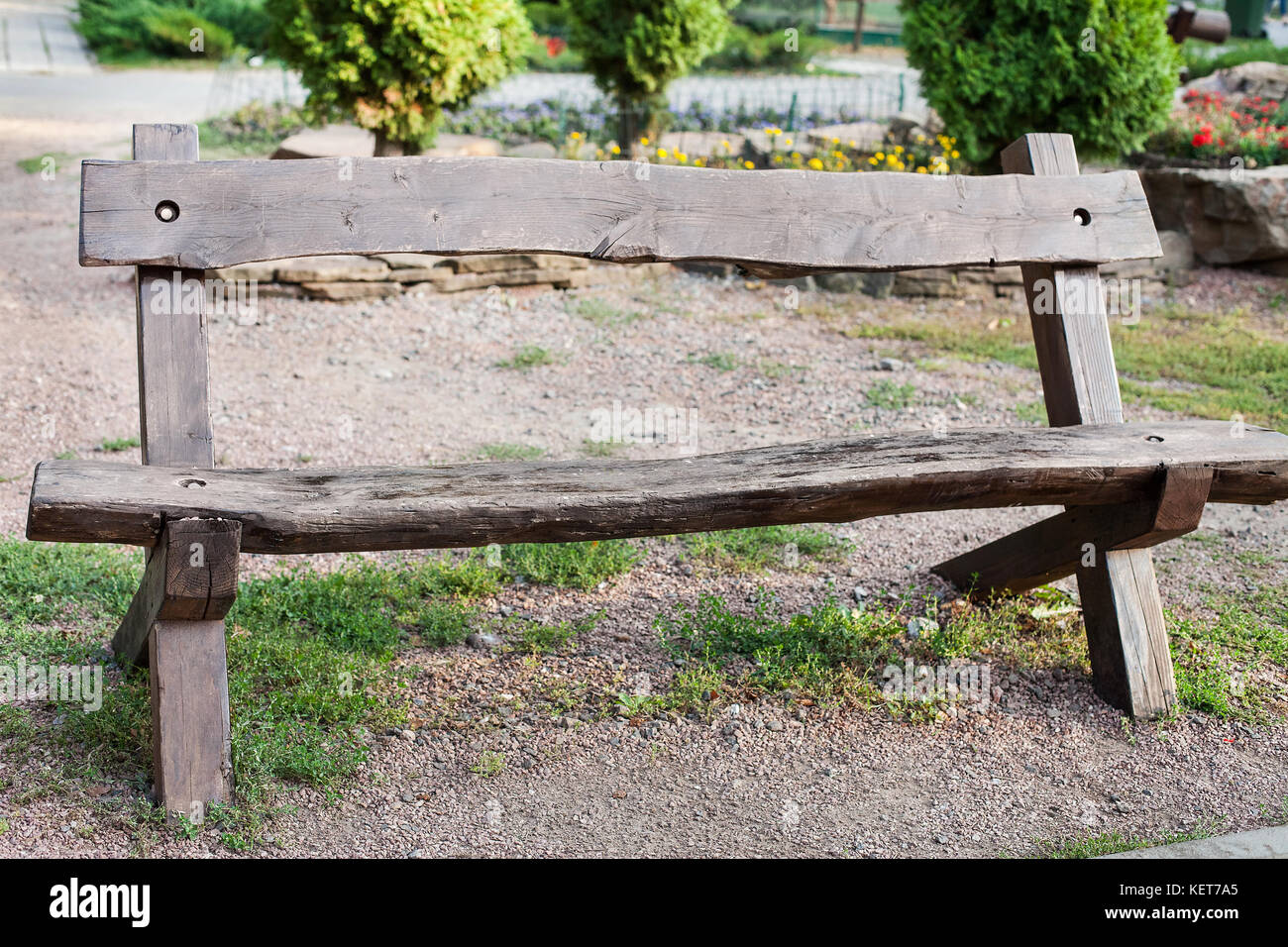 View of stylish wooden beanch in park Stock Photo - Alamy