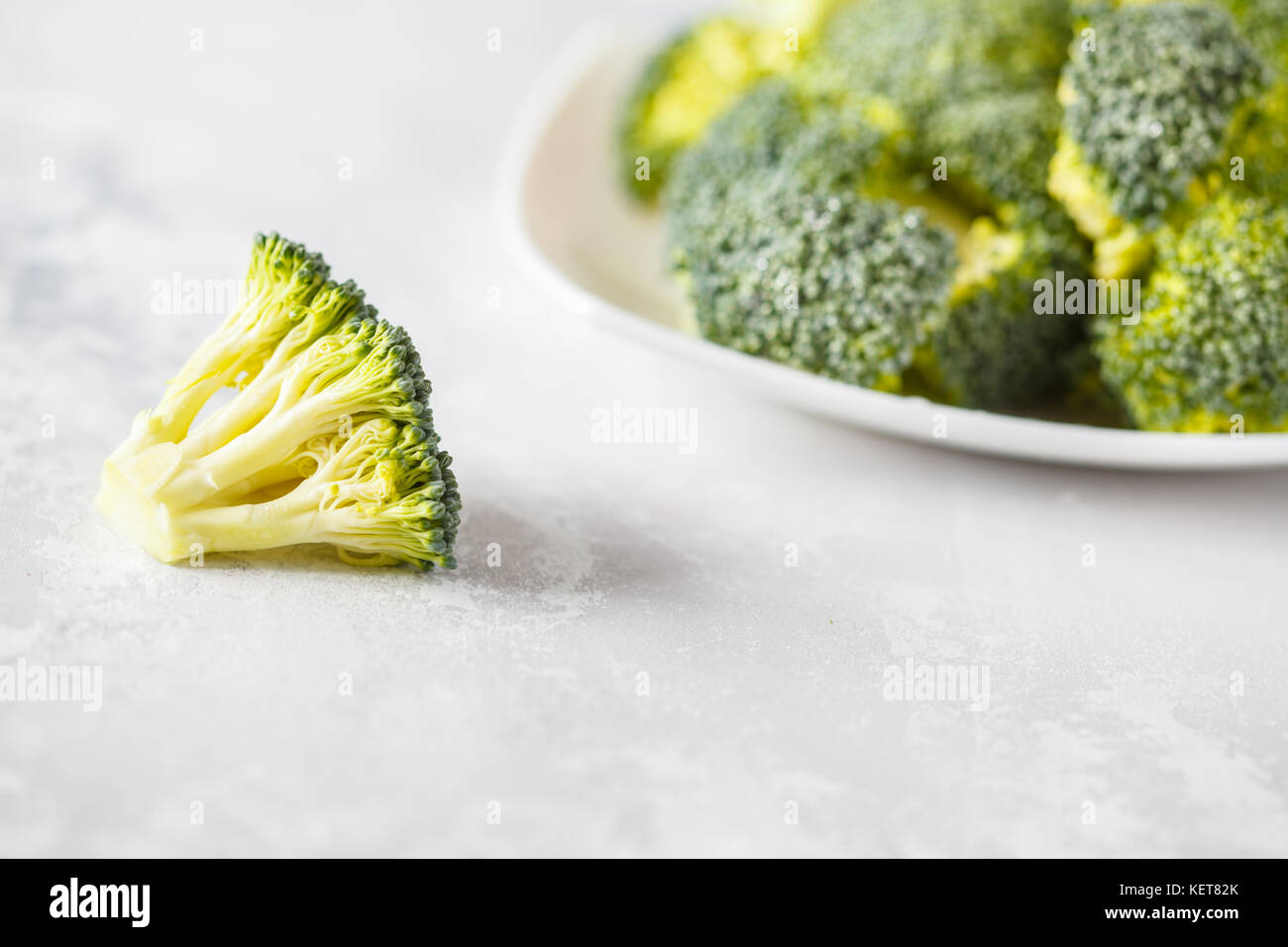 Fresh raw broccoli on a light background. Healthy vegan food concept ...