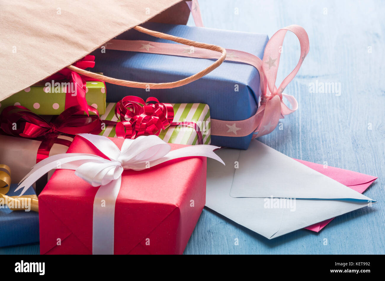 Multitude of colorful gift boxes and two envelopes coming out from a ...