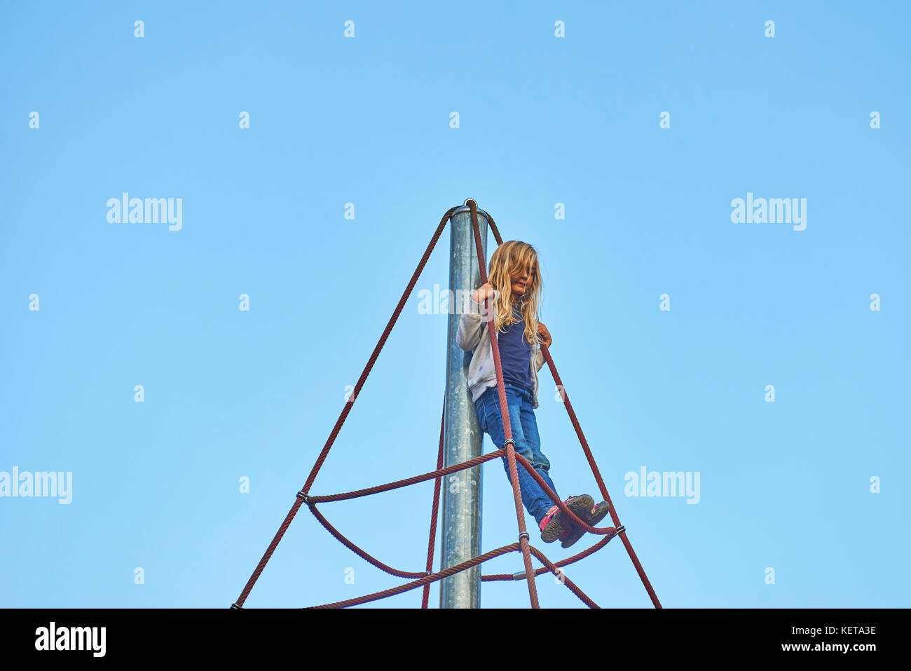 Active young child girl climbing the spider web playground activity ...