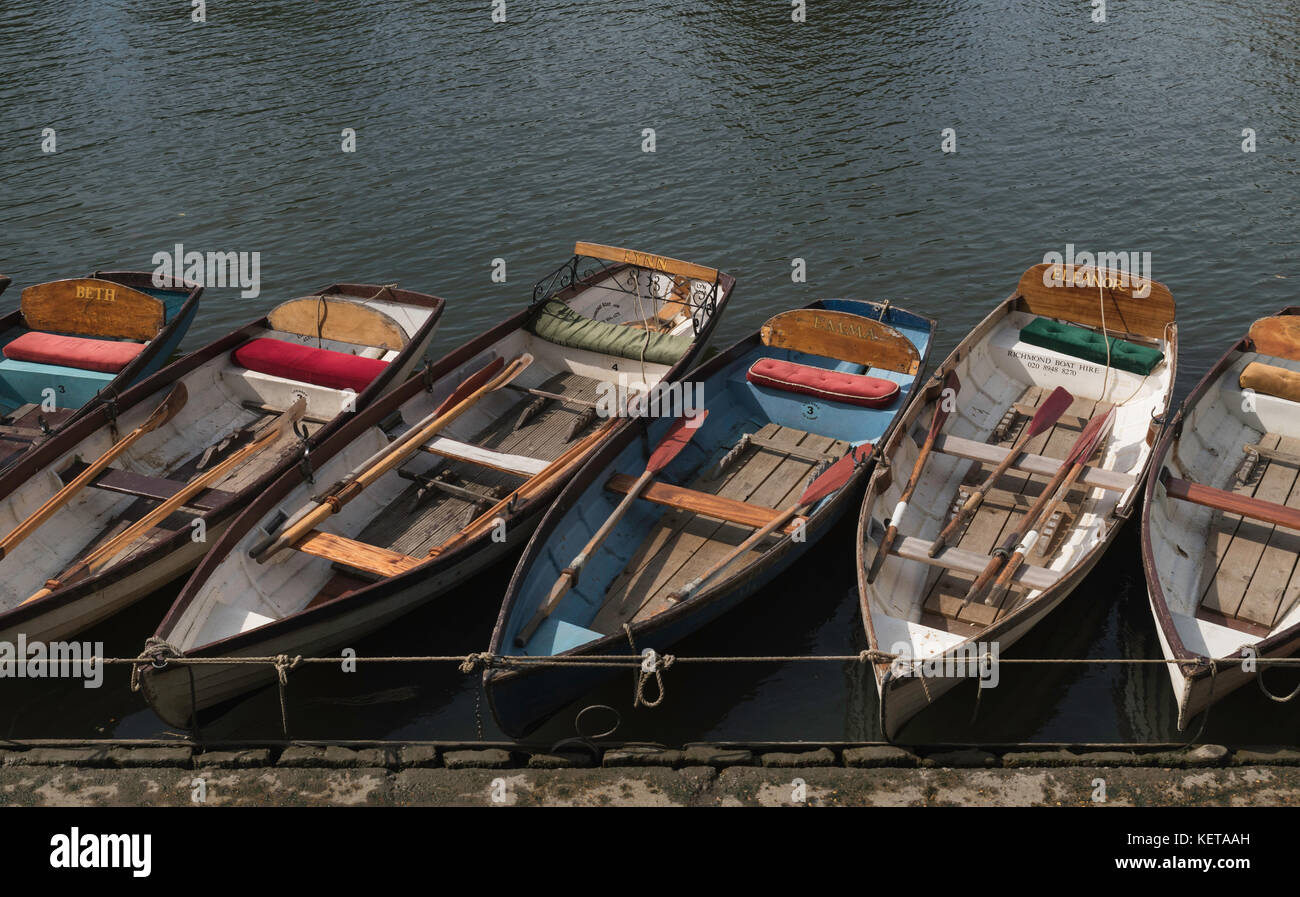 Moored wooden rowing boats on River Thames at Richmond, England, UK ...