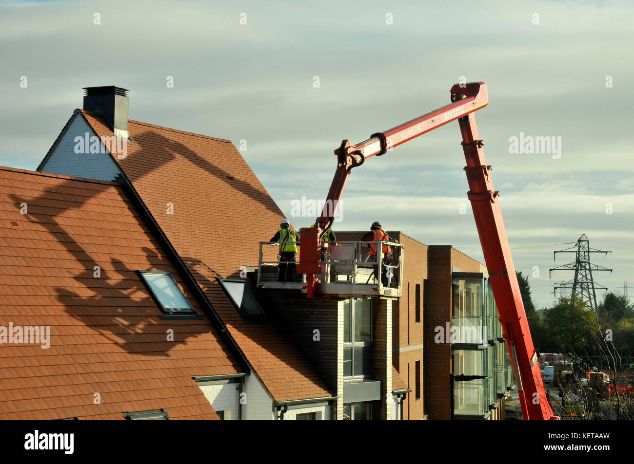 Workmen fixing roof from a crane Stock Photo - Alamy