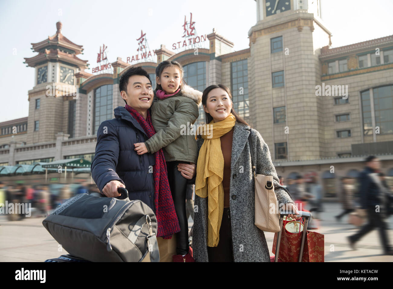 Happy family at the railway station Stock Photo - Alamy