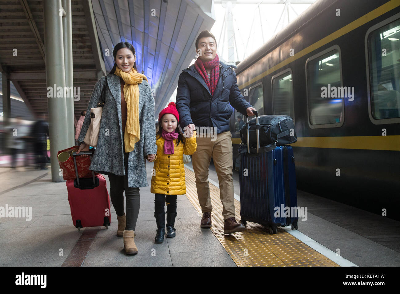 Happy family at the station platform Stock Photo - Alamy