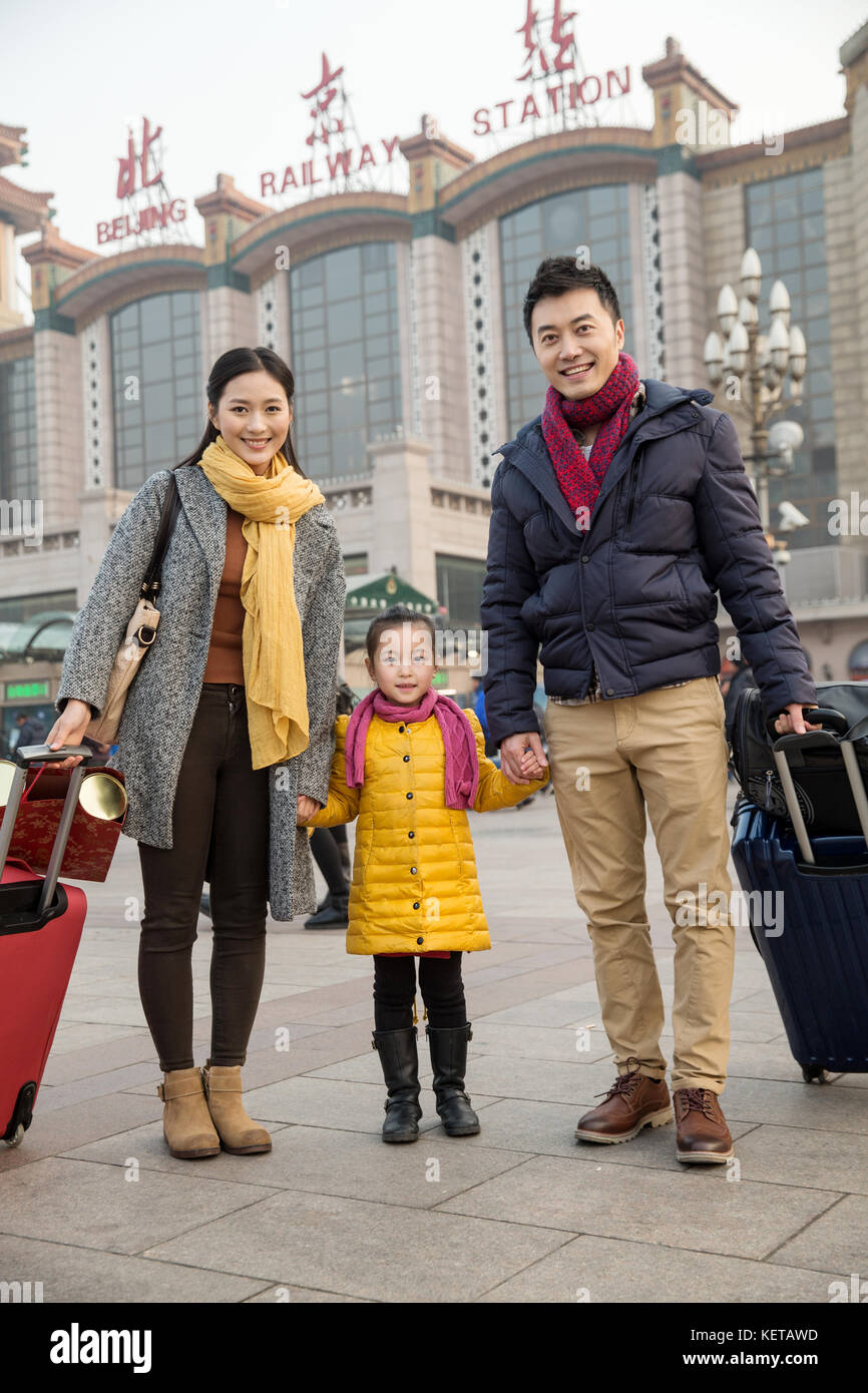 Happy family at the railway station Stock Photo - Alamy