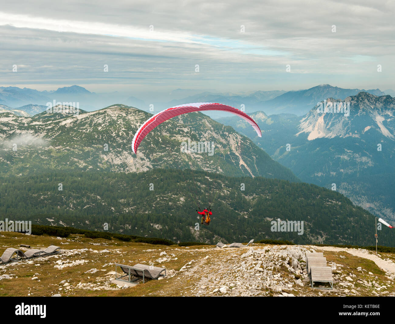 A paraglider taking of from a peak in the Austrian alps, Salzkammergut ...