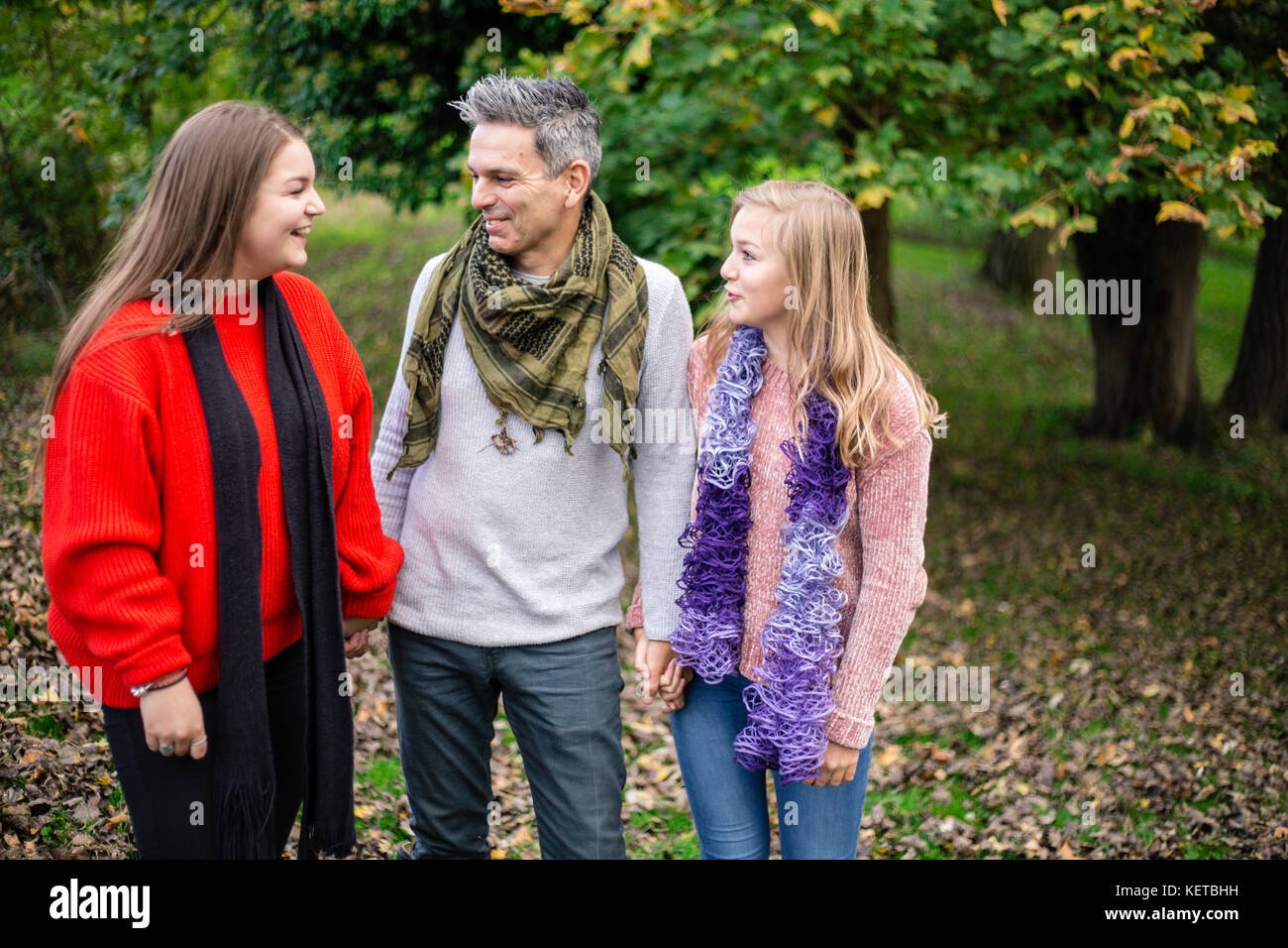 middle aged father socialising with teenage daughters Stock Photo - Alamy