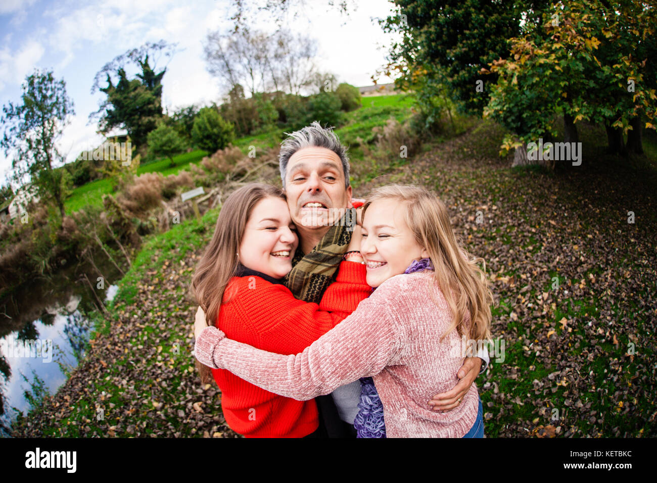 middle aged father socialising with teenage daughters Stock Photo - Alamy