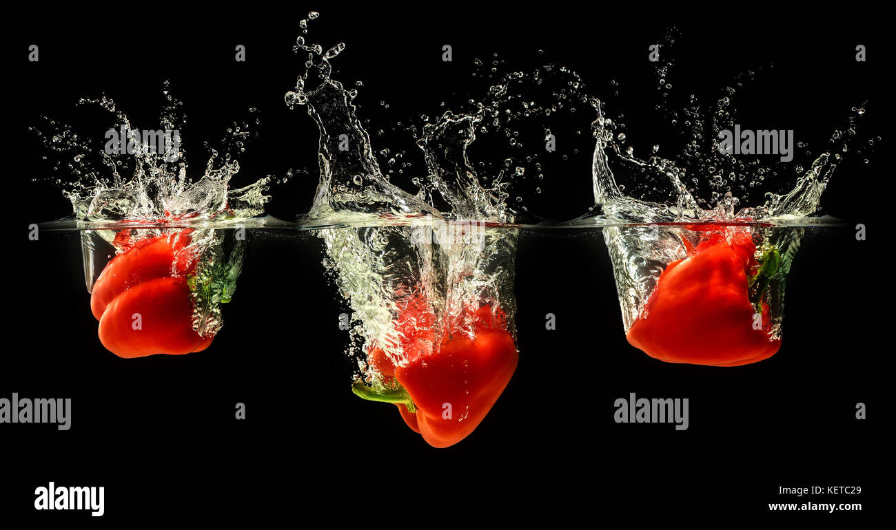 Red bell pepper falling in water Stock Photo - Alamy