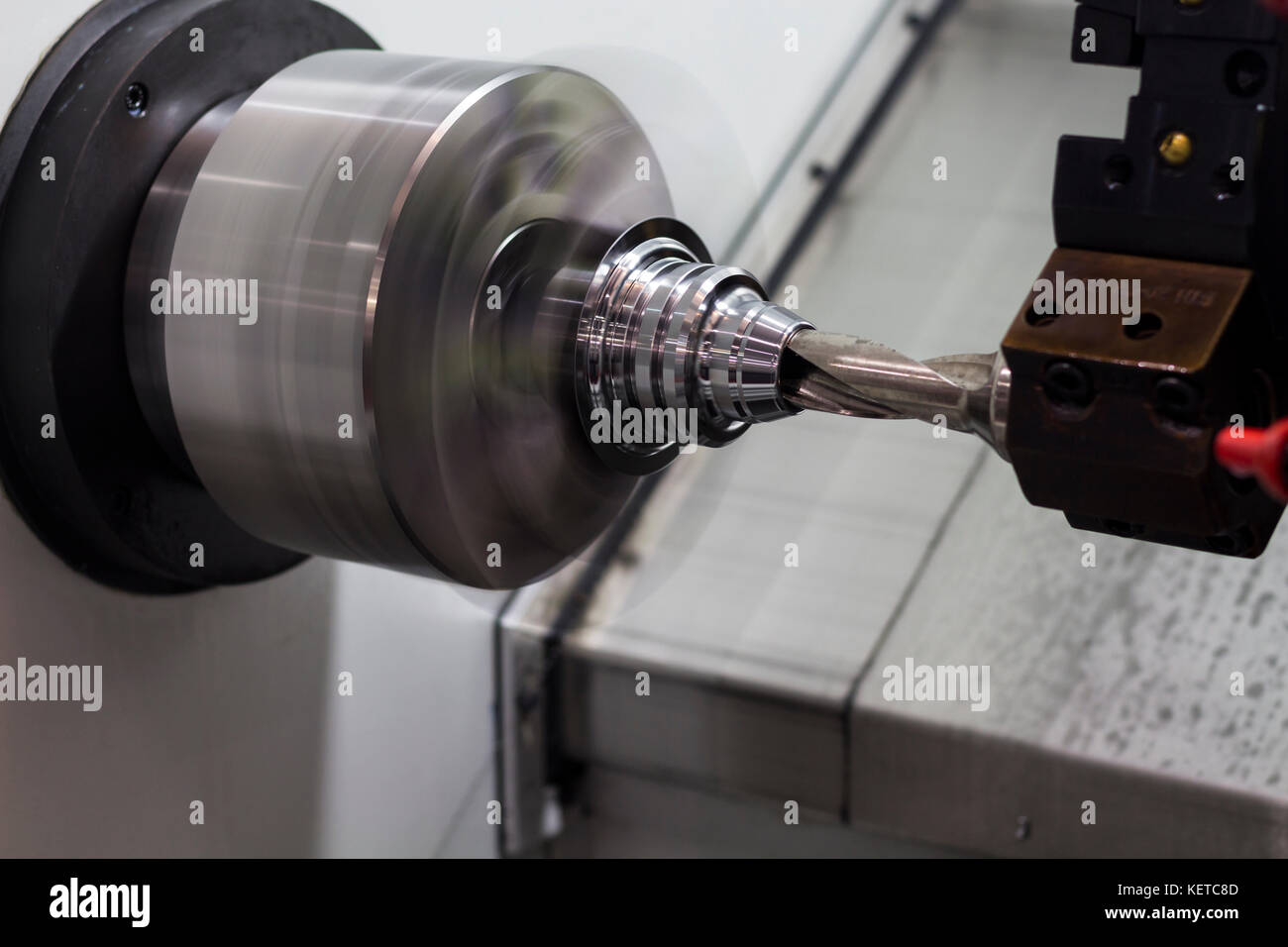 workpiece rotating in a CNC lathe machine : Side view Stock Photo - Alamy