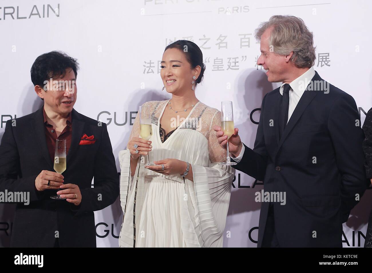 Chinese actress Gong Li (white dress) attends a promotional event for ...