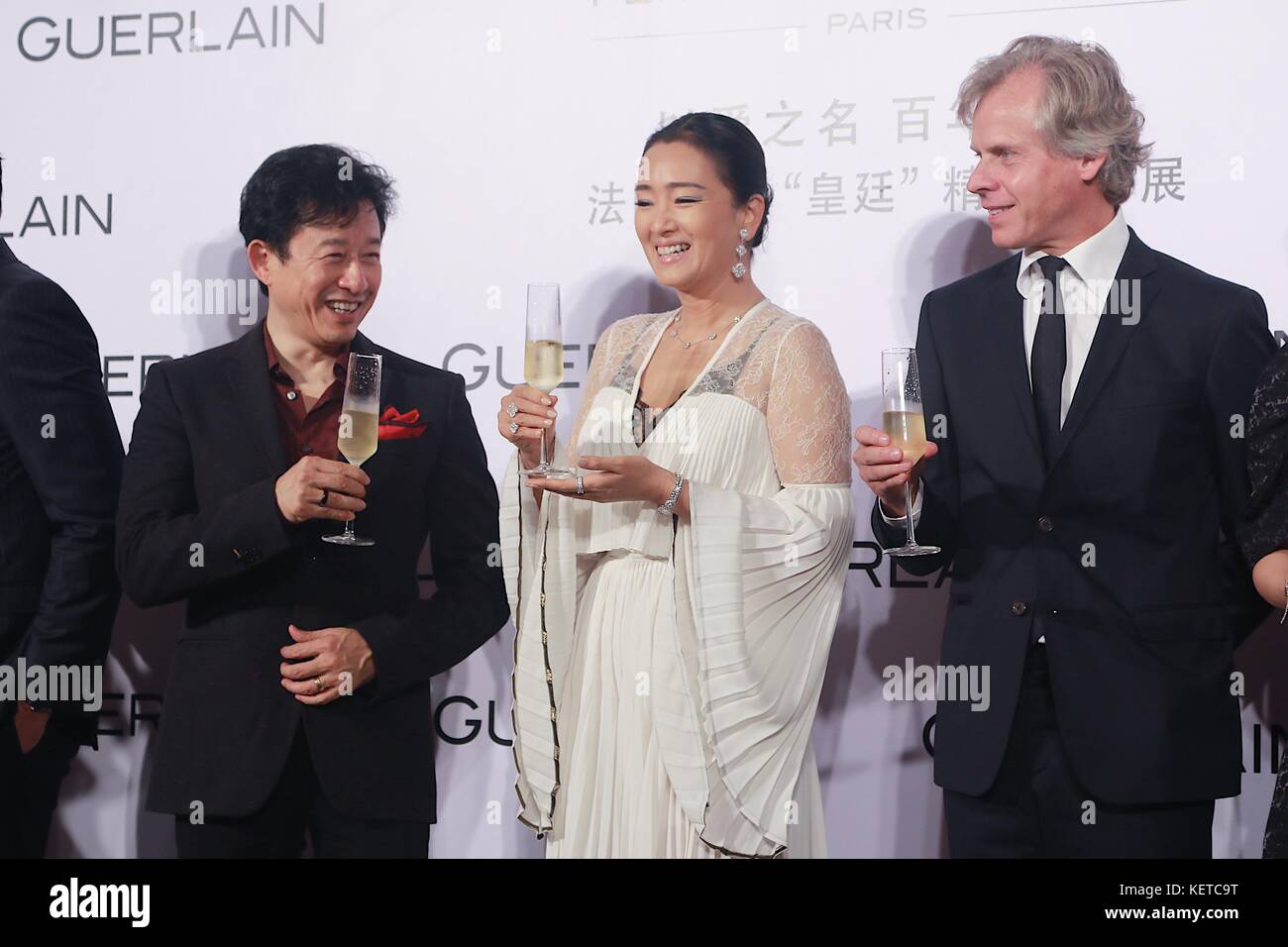 Chinese actress Gong Li (white dress) attends a promotional event for ...