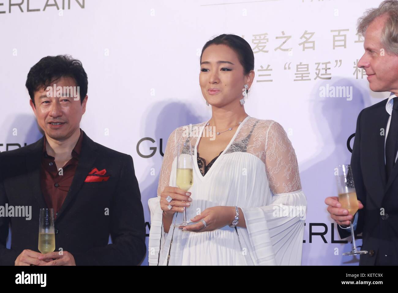 Chinese actress Gong Li (white dress) attends a promotional event for ...