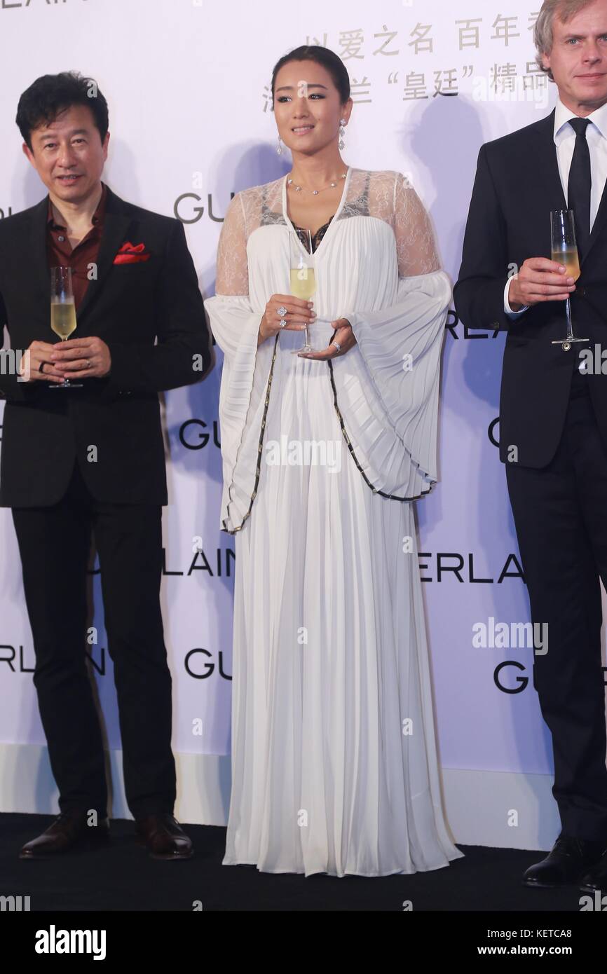 Chinese actress Gong Li (white dress) attends a promotional event for ...
