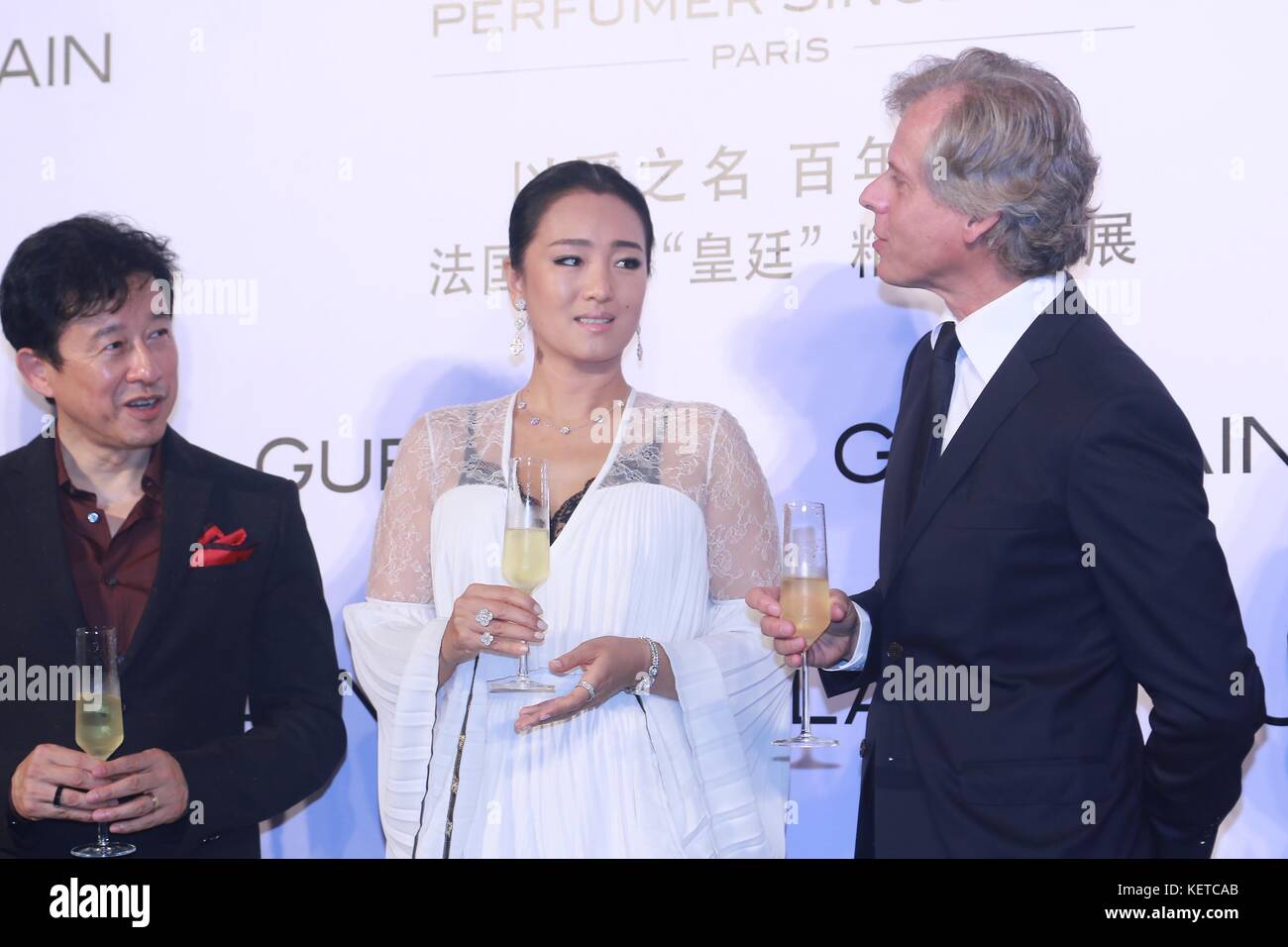 Chinese actress Gong Li (white dress) attends a promotional event for ...