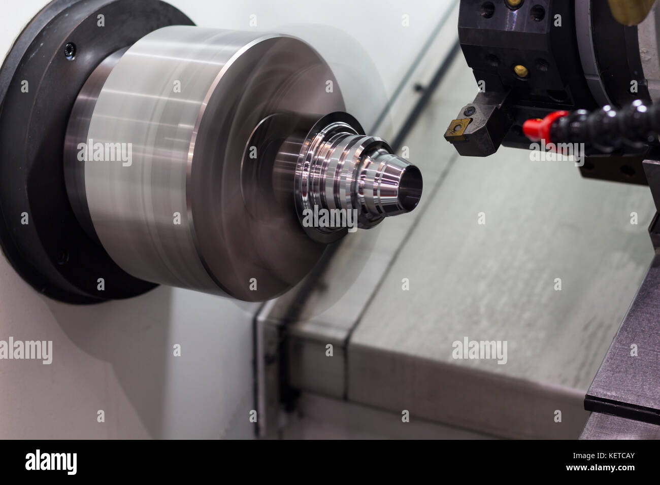workpiece rotating in a CNC lathe machine : Side view Stock Photo - Alamy