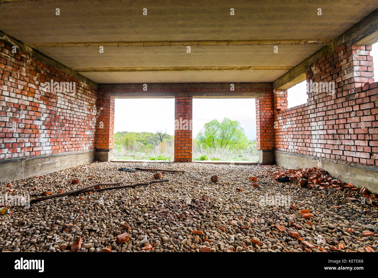 Interior of an old building under construction. Orange brick walls in a ...
