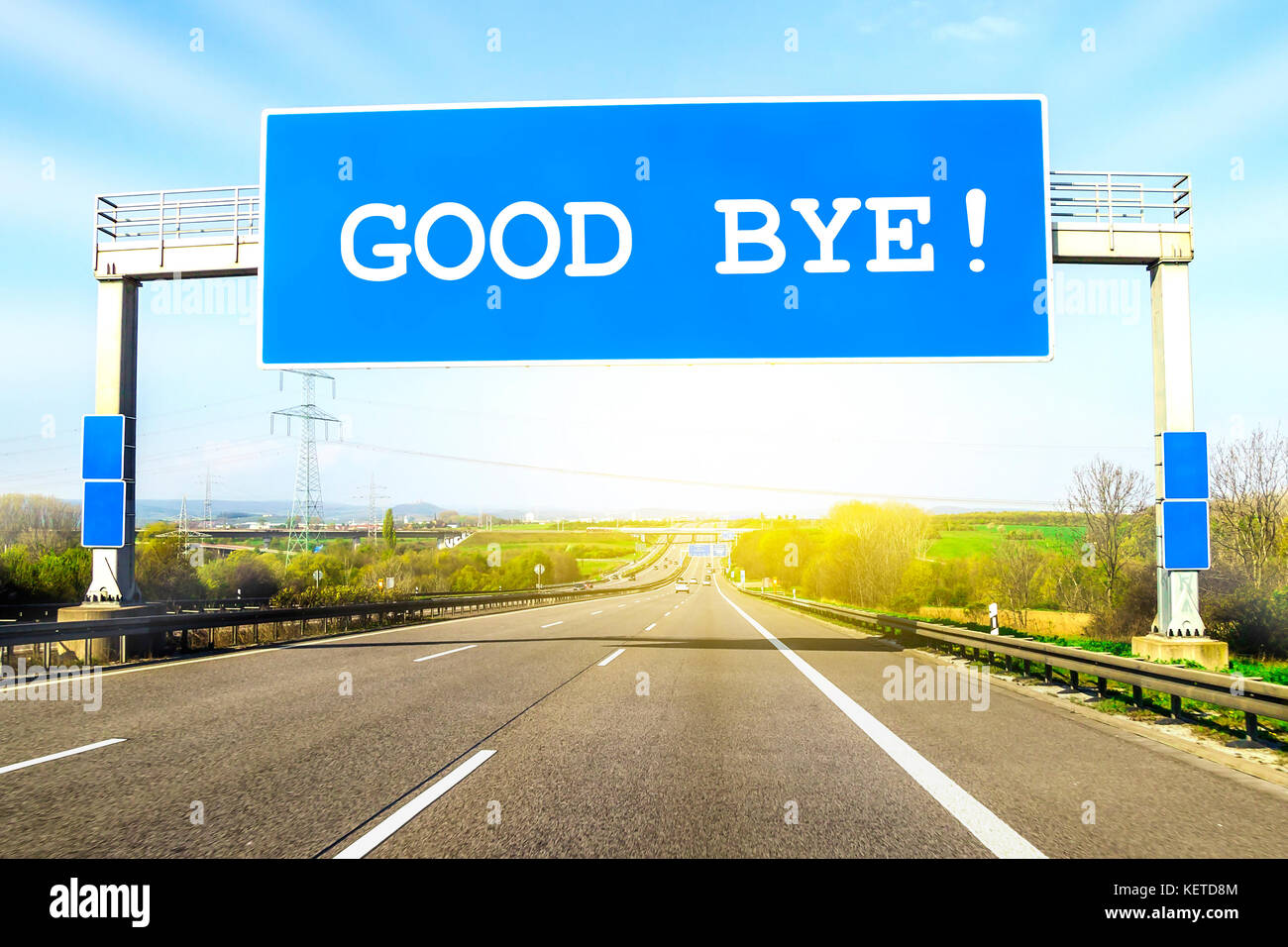Blue freeway sign over the road on sunny day with words Good Bye on it ...