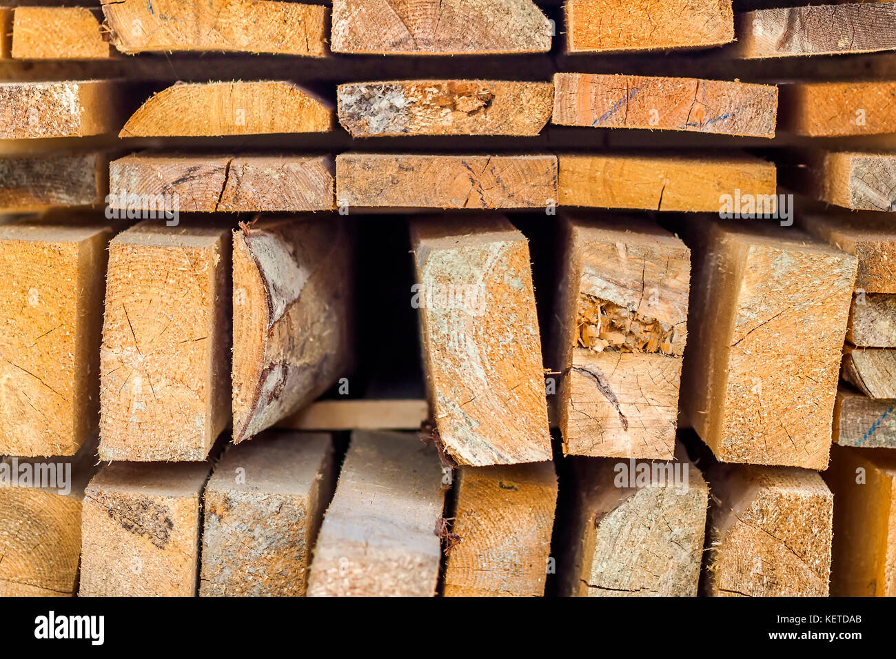 Stack of building lumber at construction site with narrow depth of ...