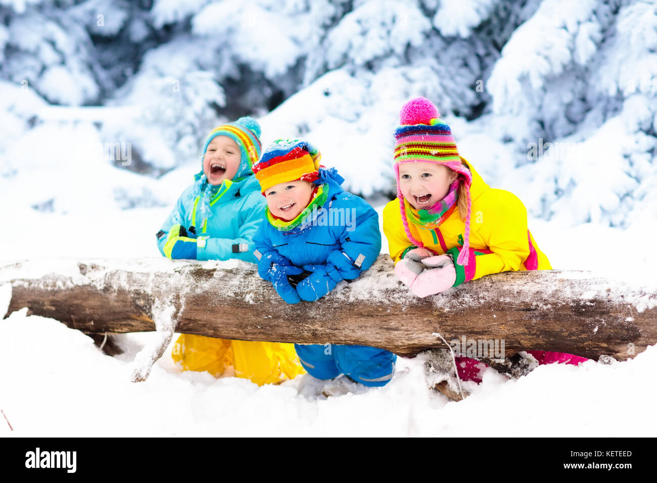 Kids playing in snow. Children play outdoors on snowy winter day. Boy ...