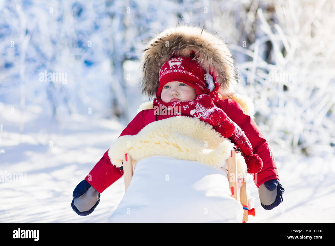 Sled and snow fun for kids. Baby sledding in snowy winter park. Little ...