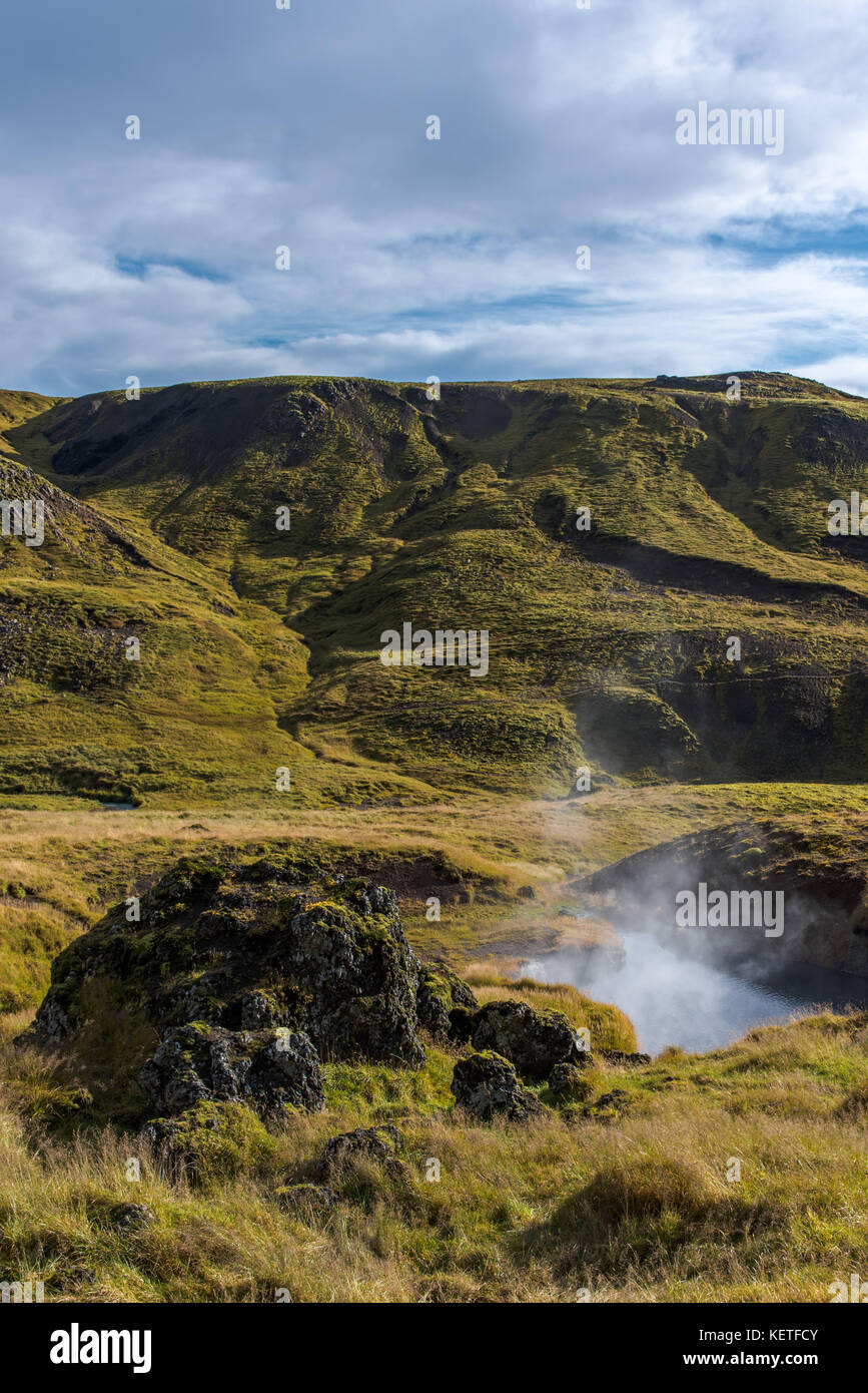 Steam overt he green hills Stock Photo - Alamy