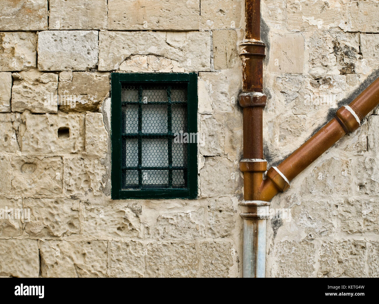 Little window and old drain pipes on eroded wall Stock Photo - Alamy