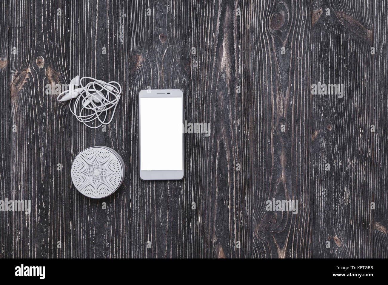 Portative sound system with earphones and mobile phone with blank ...