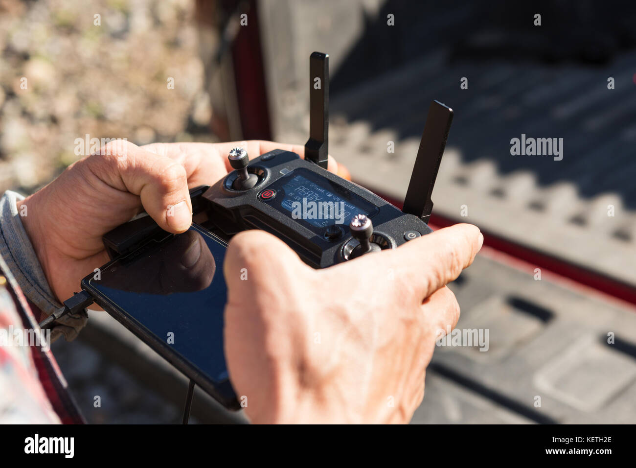 A male's hands operating a joystick of a Mavic Pro drone Stock Photo ...