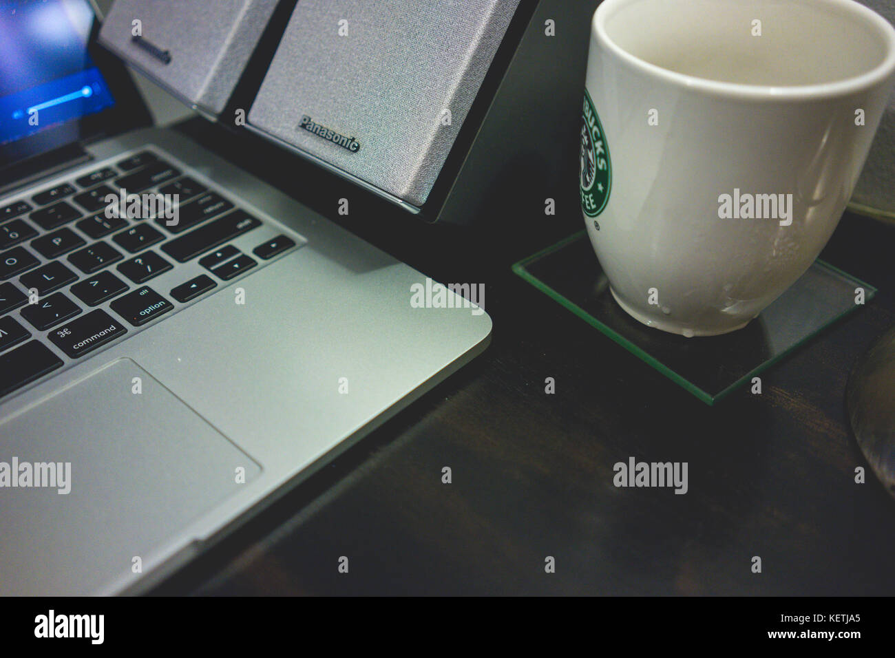 Closeup desktop work surface with Starbucks and MacBook Stock Photo - Alamy