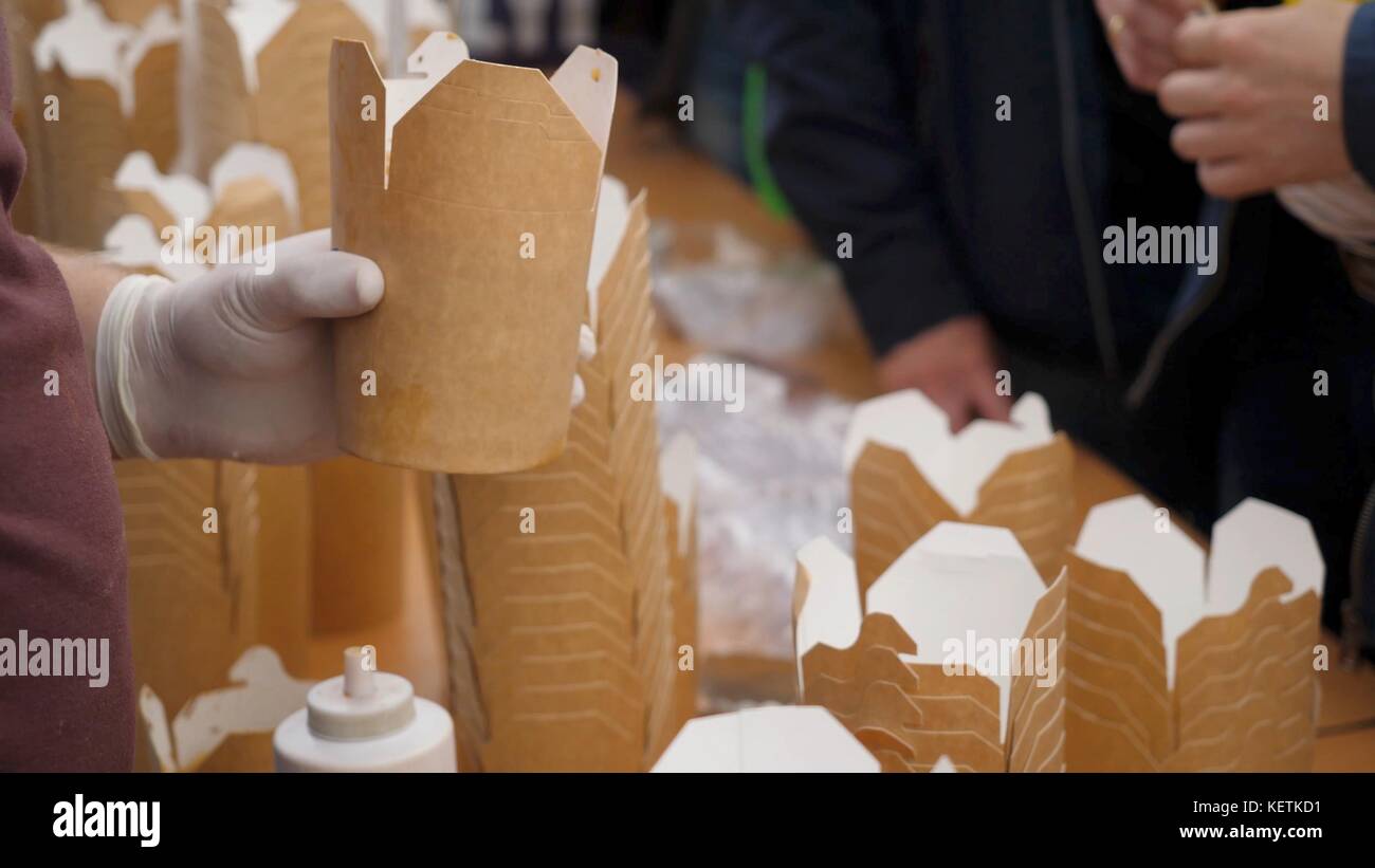 Hands putting take-out food container, close-up. Food delivery. Close ...