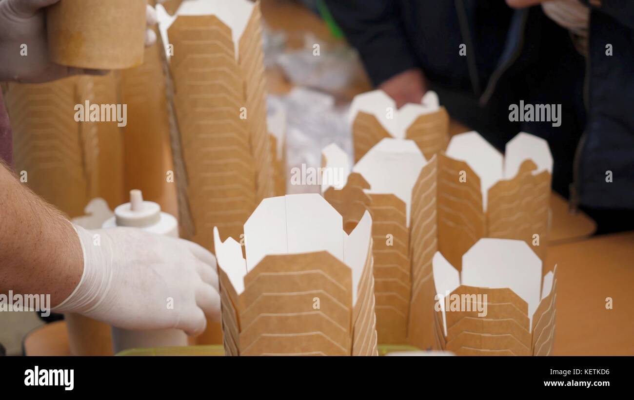 Hands putting take-out food container, close-up. Food delivery. Close ...